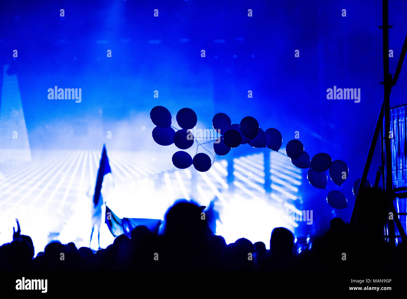 Partying crowd, stage lights and balloons at a live concert Stock Photo ...