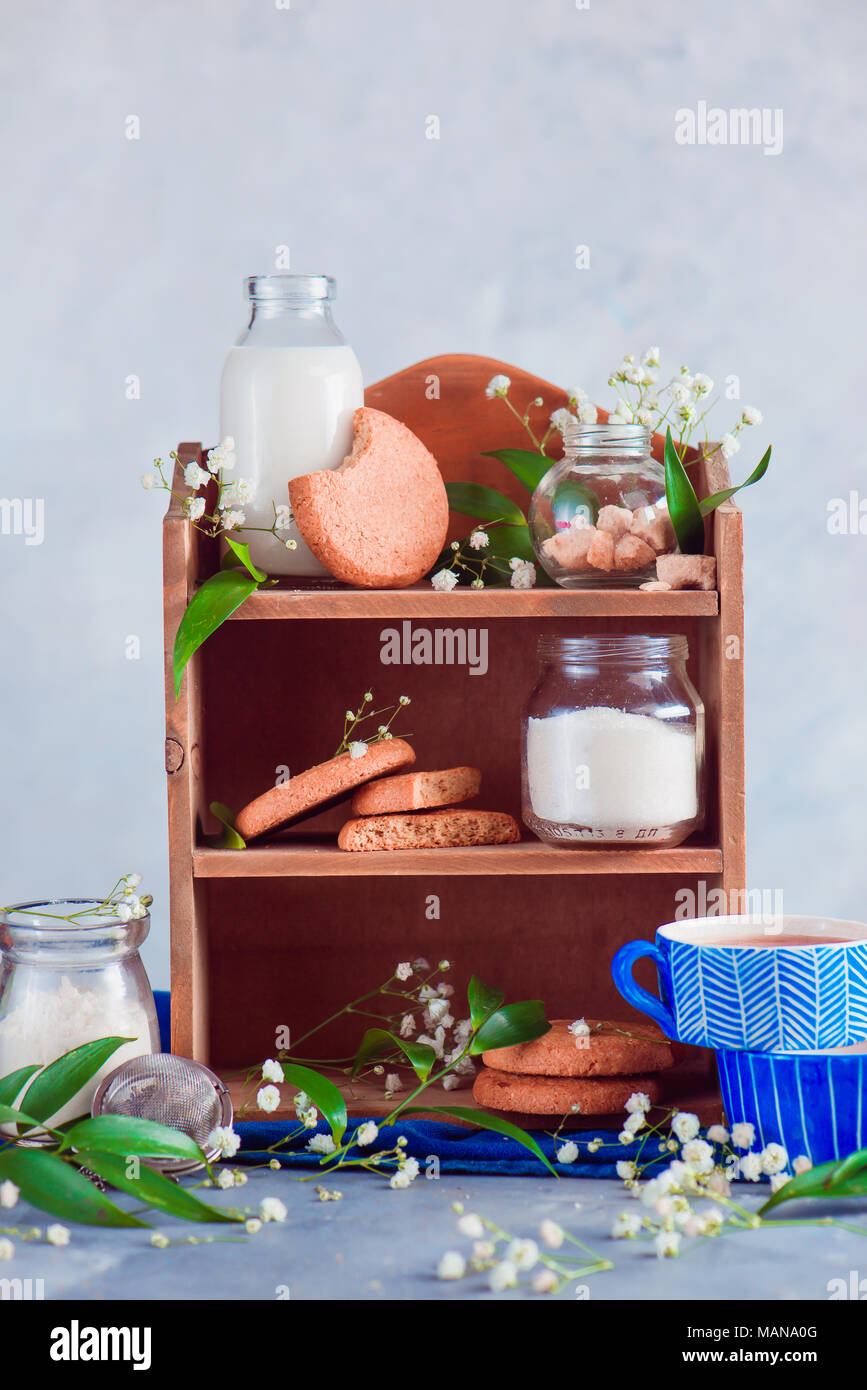 Kitchen shelf with baking ingredients for oatmeal cookies. Flour, milk ...