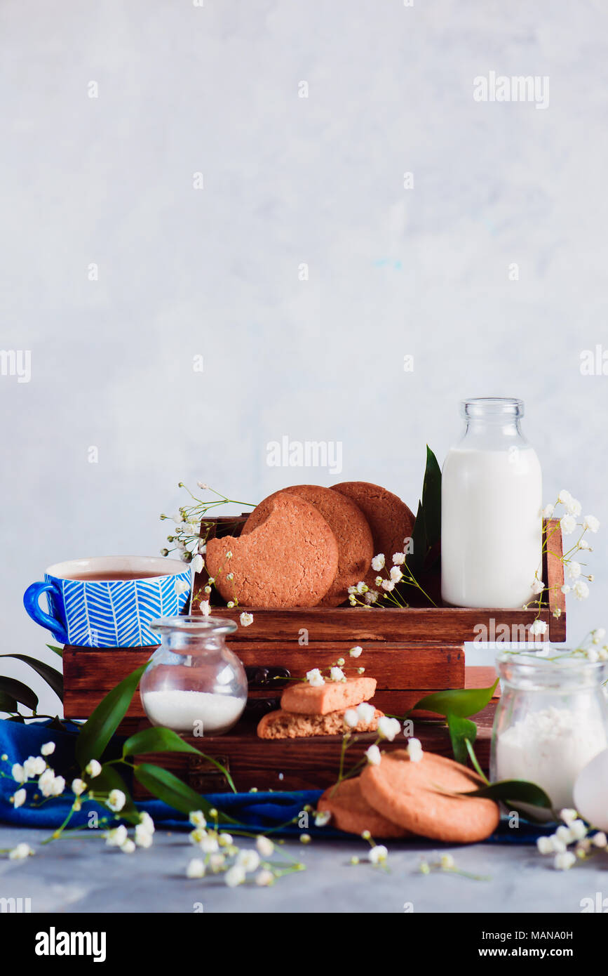 Kitchen shelf with baking ingredients for oatmeal cookies. Flour, milk ...