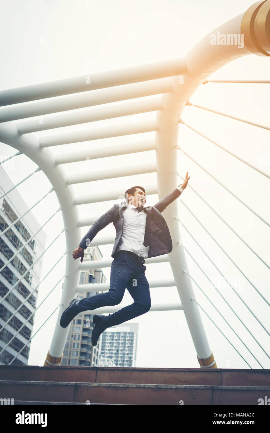 Portrait of Attractive businessman celebrates by jumping raises his ...