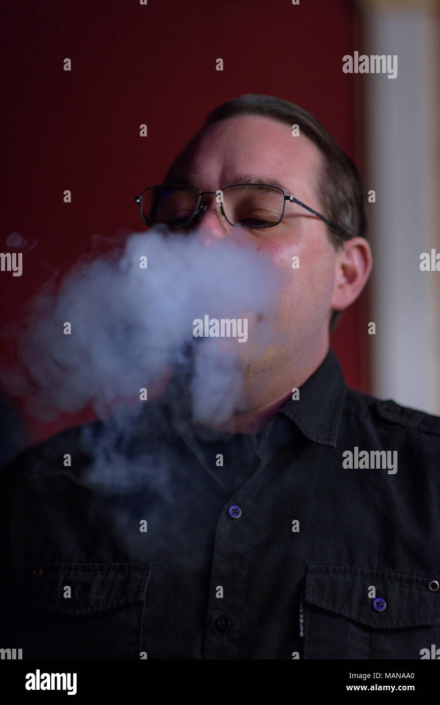 Breathe in, Breathe Out, Relax. Male Model exhaling flavorful hookah ...