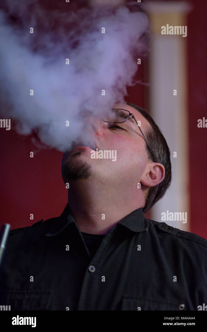 Breathe in, Breathe Out, Relax. Male Model exhaling flavorful hookah ...