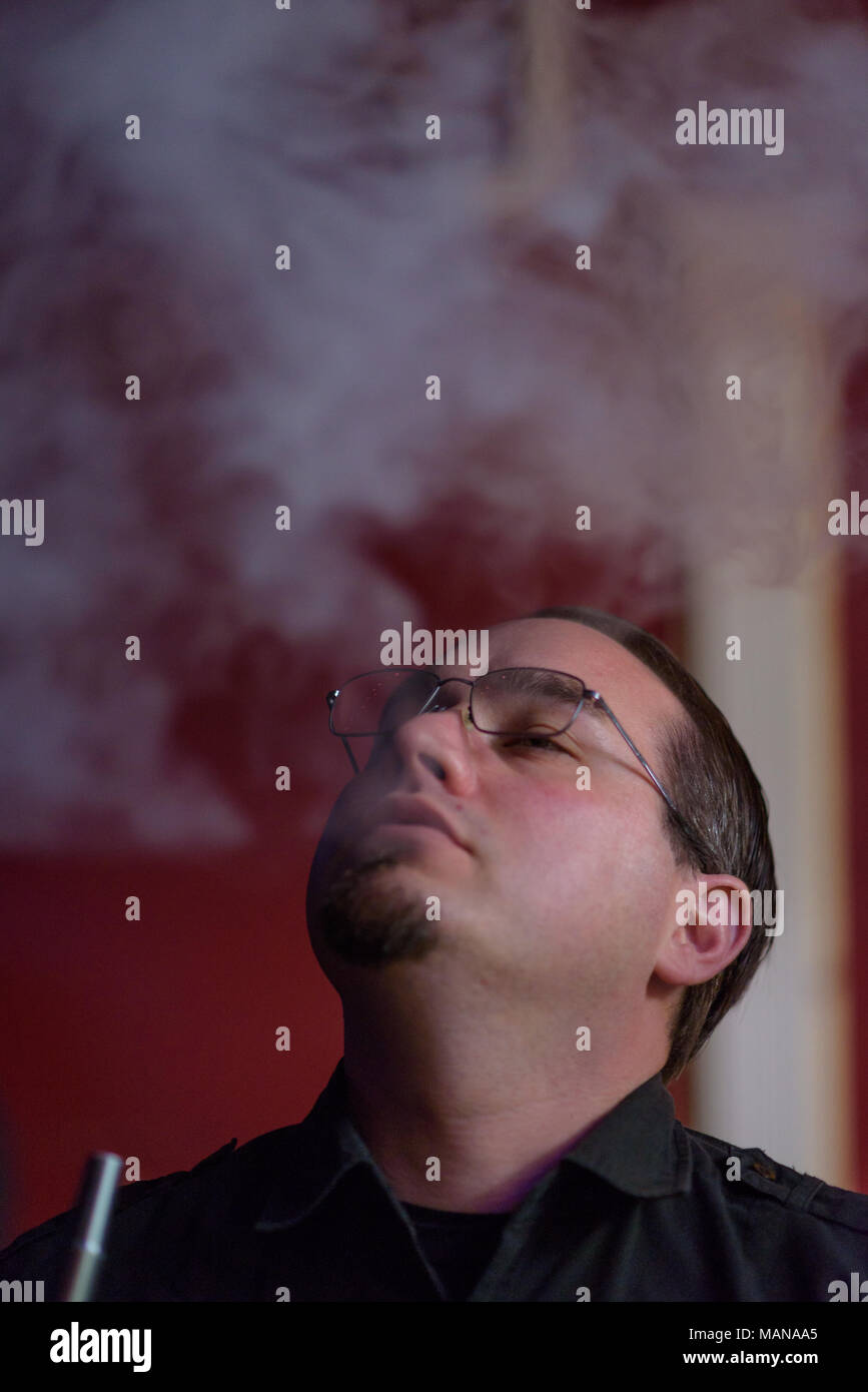 Breathe in, Breathe Out, Relax. Male Model exhaling flavorful hookah ...