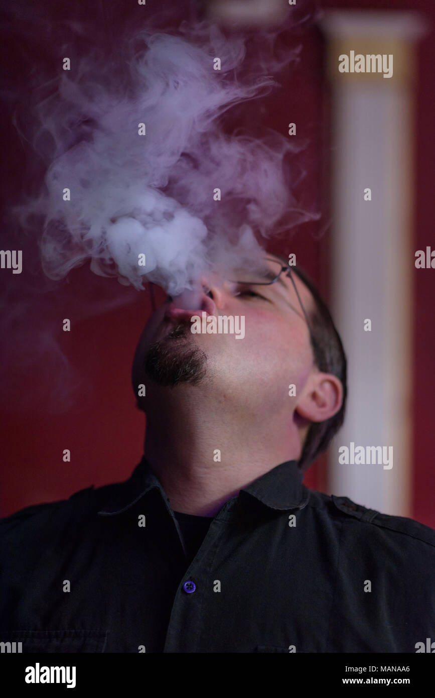 Breathe in, Breathe Out, Relax. Male Model exhaling flavorful hookah ...