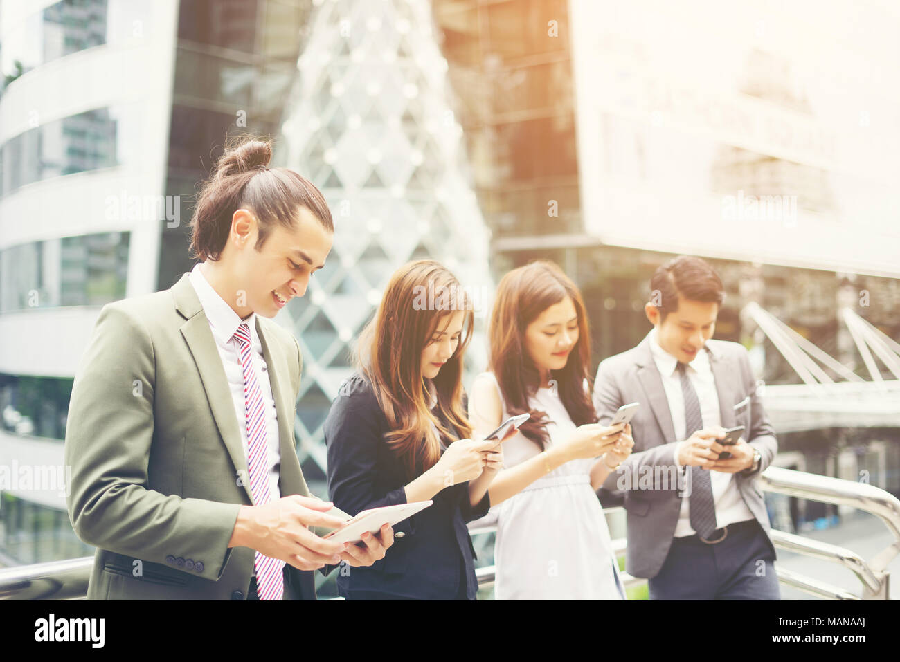 Business people using smartphone while together Stock Photo - Alamy