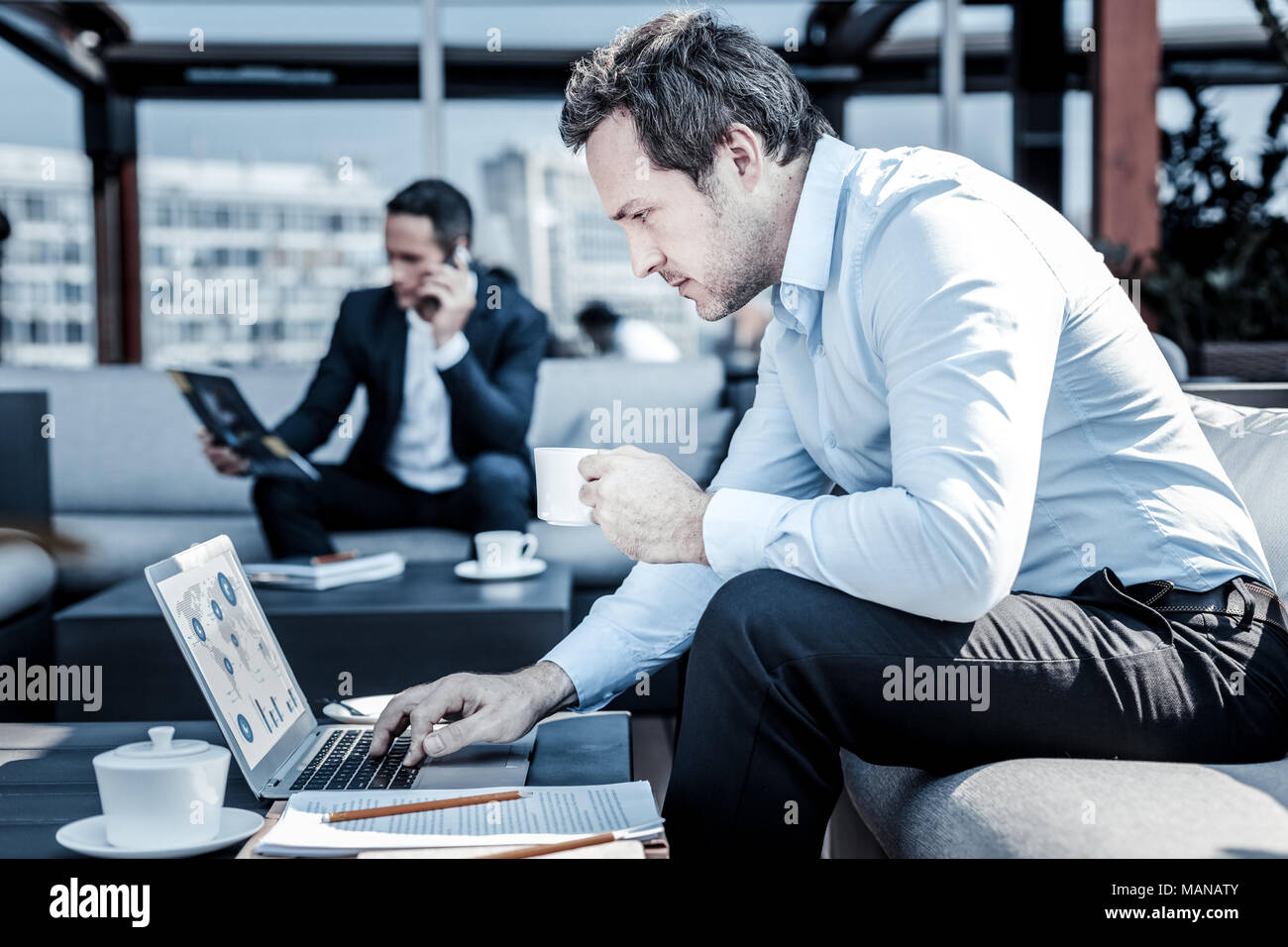 Nice smart man focusing on his work Stock Photo - Alamy