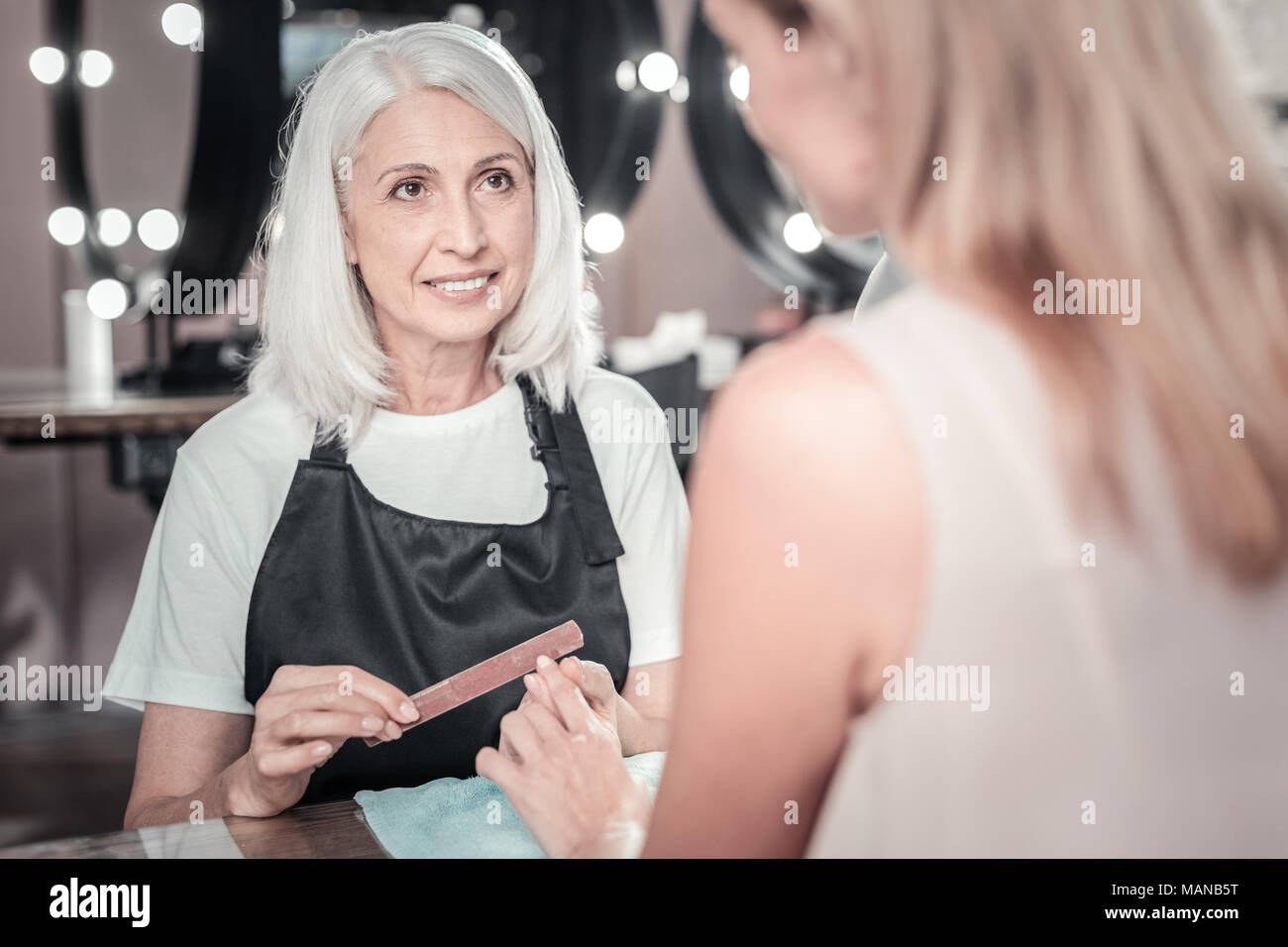 Professional nail master doing manicure Stock Photo - Alamy