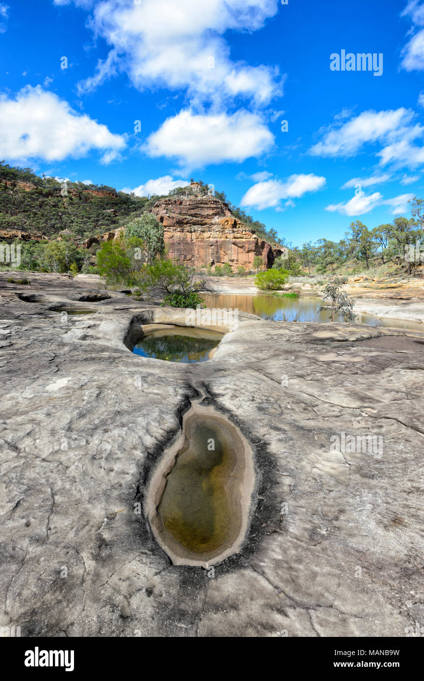 Rock pool in eroded riverbed at Porcupine Gorge National Park, with a ...