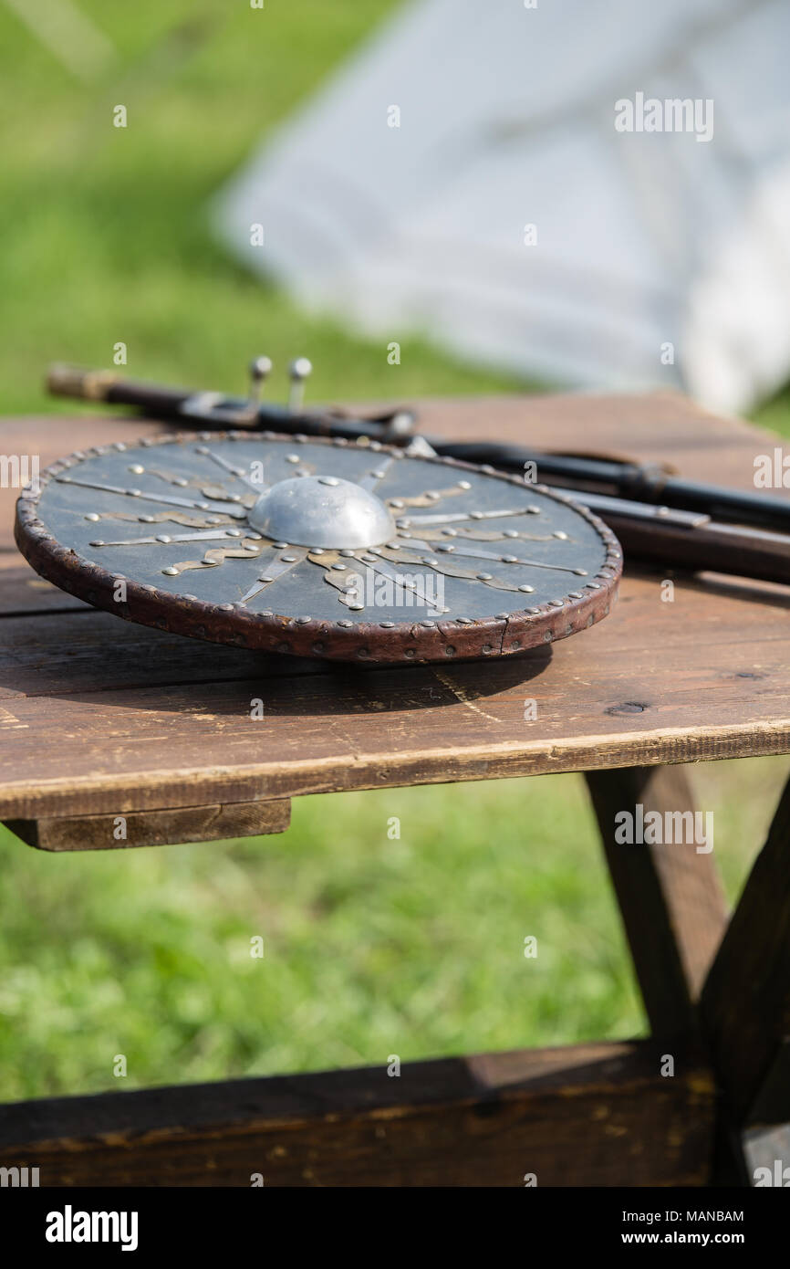 Circular and Metallic Shield on Wooden table: Medieval Metallic Armors ...