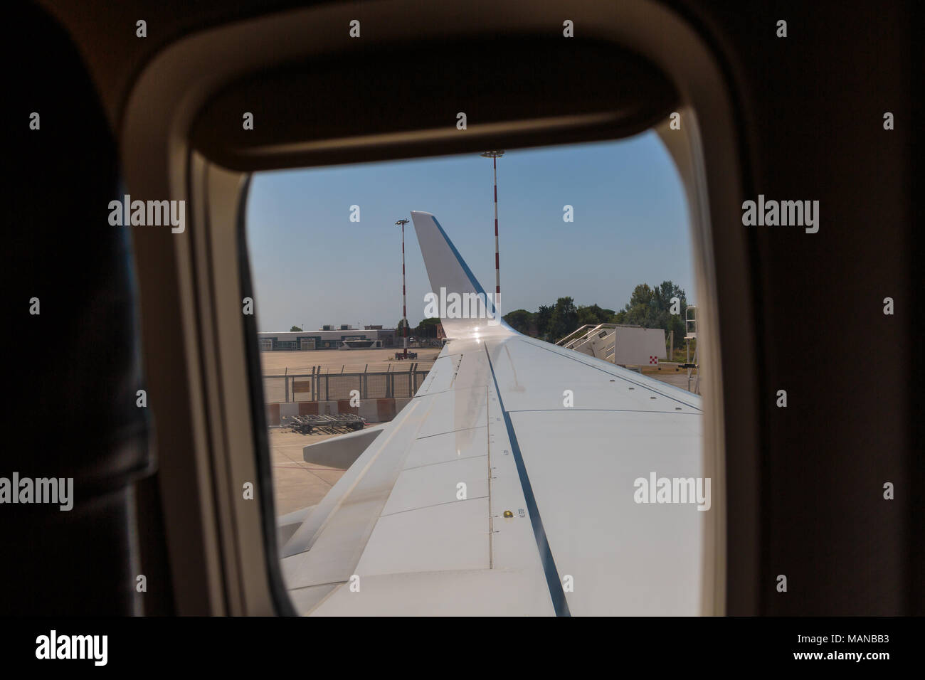 Looking Outside a Window of an Aircraft Cabin: White Airplane Wing ...
