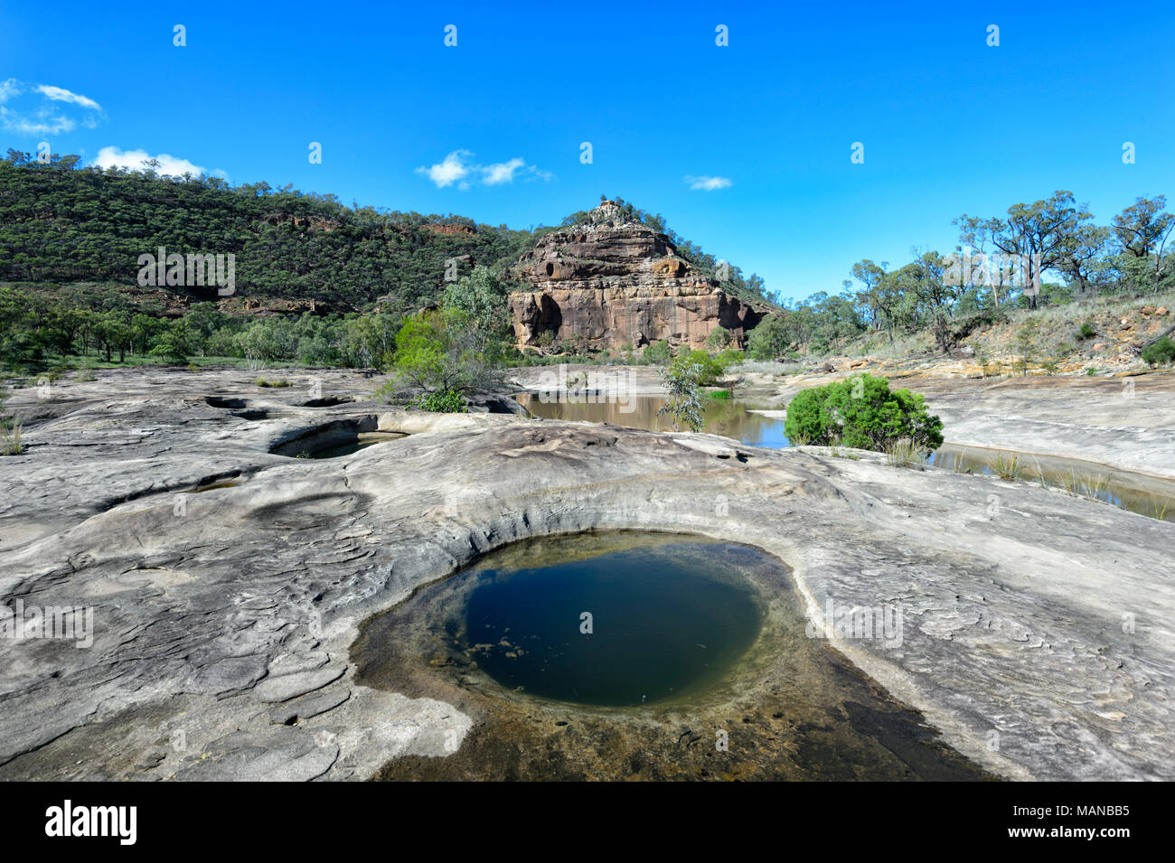 Rock pool in eroded riverbed at Porcupine Gorge National Park, with a ...