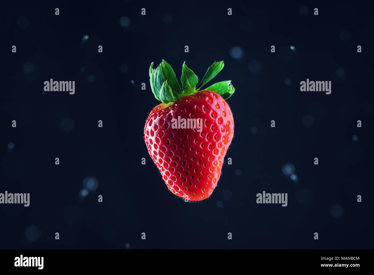 Strawberry isolated on black background Stock Photo - Alamy