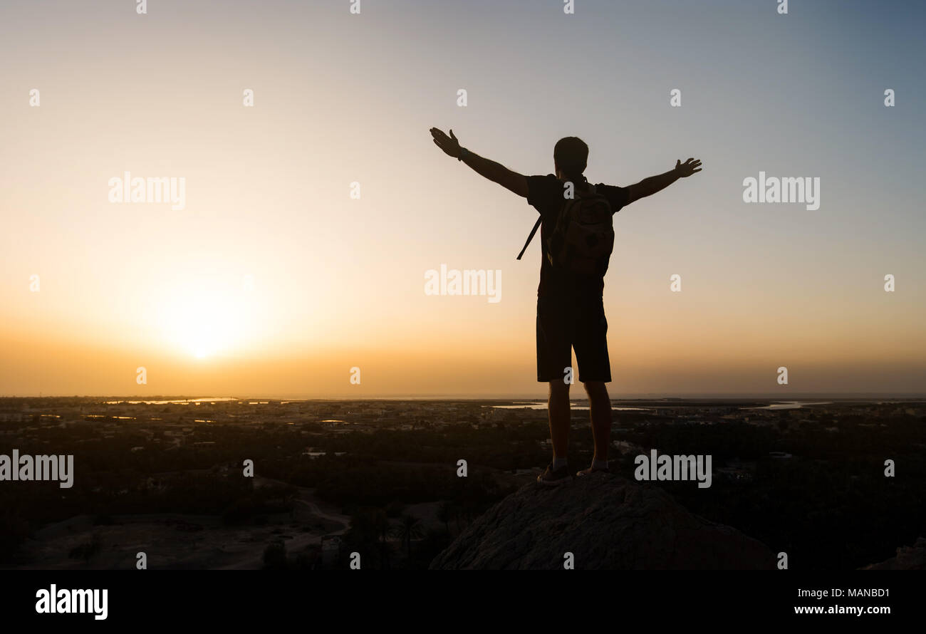 Man standing on top of mountain with arms raised hi-res stock ...