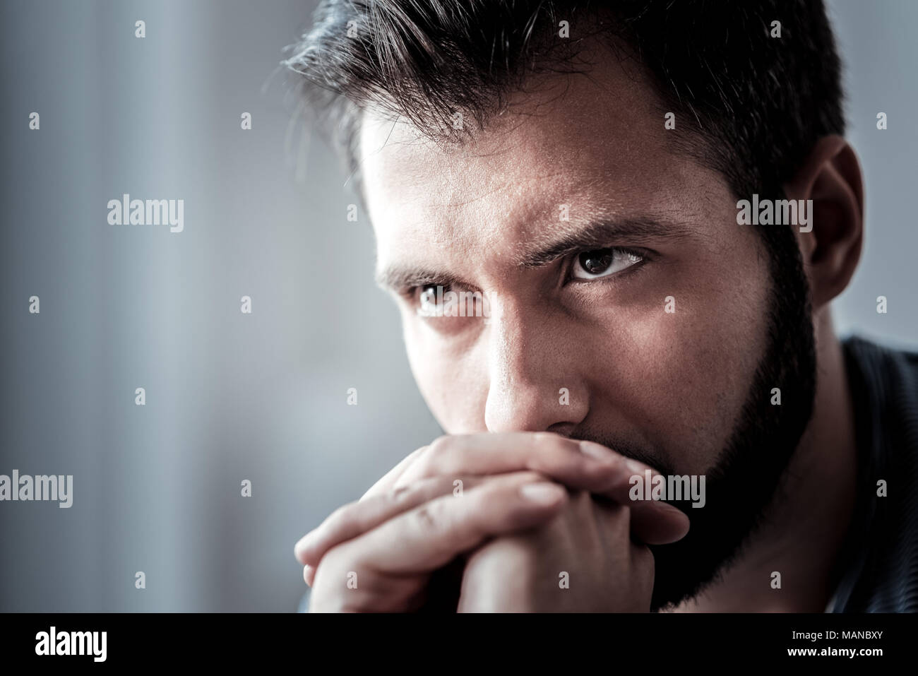 Portrait of an unhappy young man Stock Photo - Alamy
