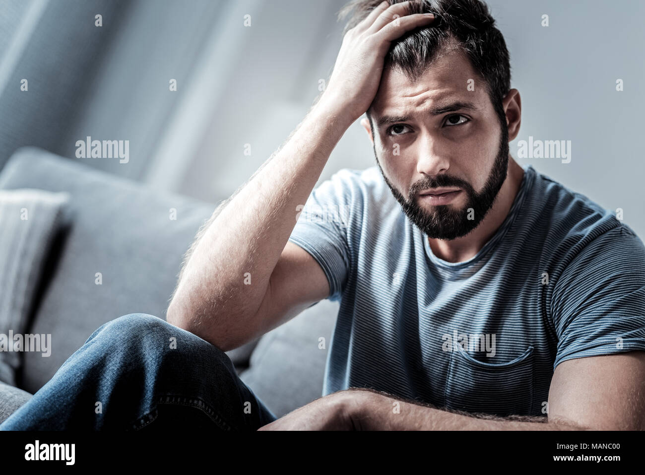 Sad young man being in a difficult situation Stock Photo - Alamy