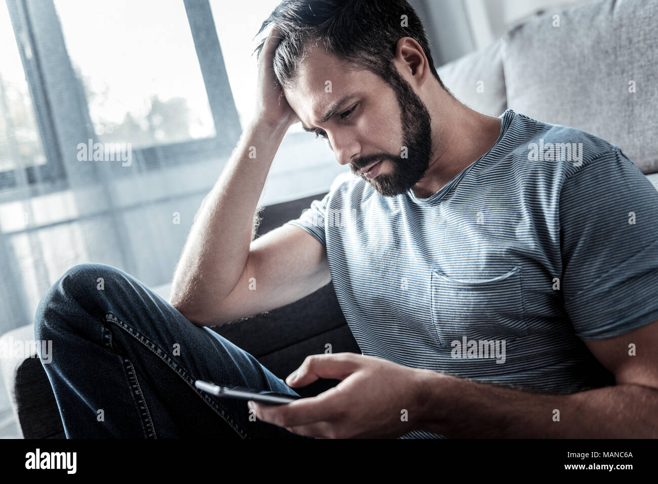 Cheerless unhappy man suffering hi-res stock photography and images - Alamy