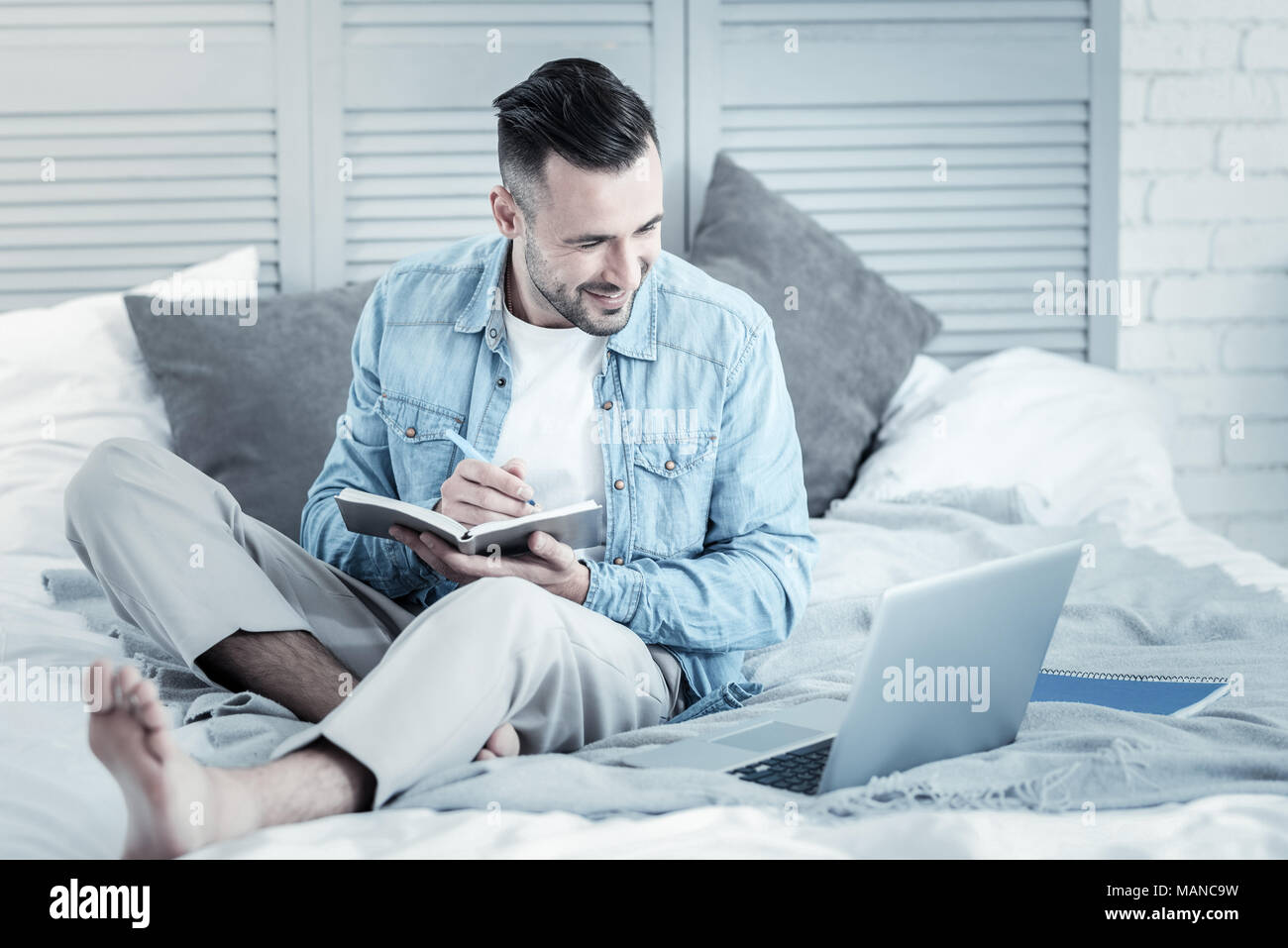 Positive handsome man looking at the laptop screen Stock Photo - Alamy