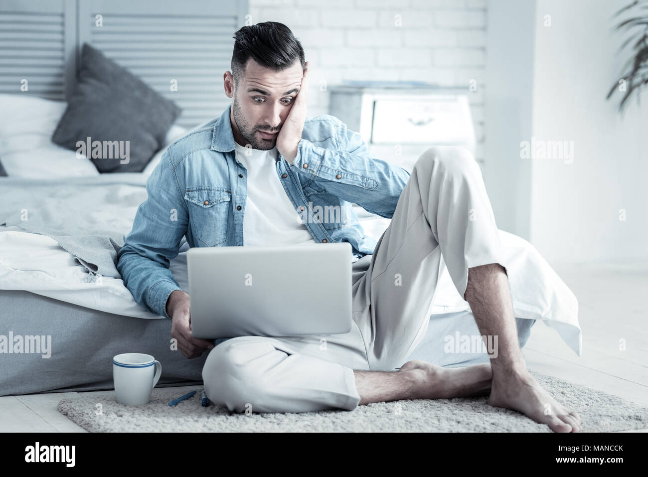 Nice handsome man holding his cheek Stock Photo - Alamy