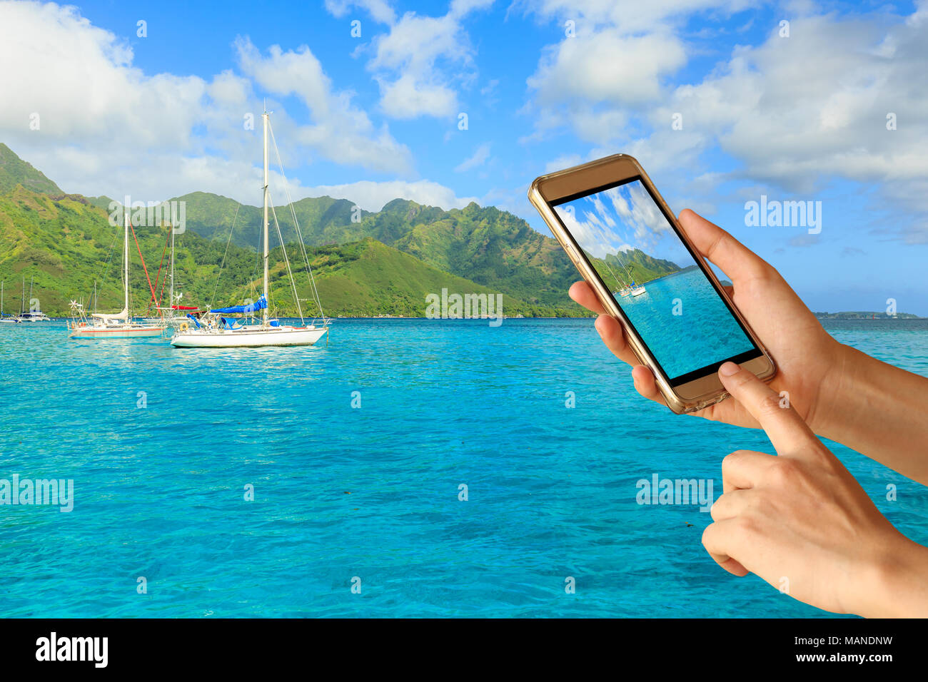 Woman hand hold and touch screen smart phone over Beautiful sea and ...