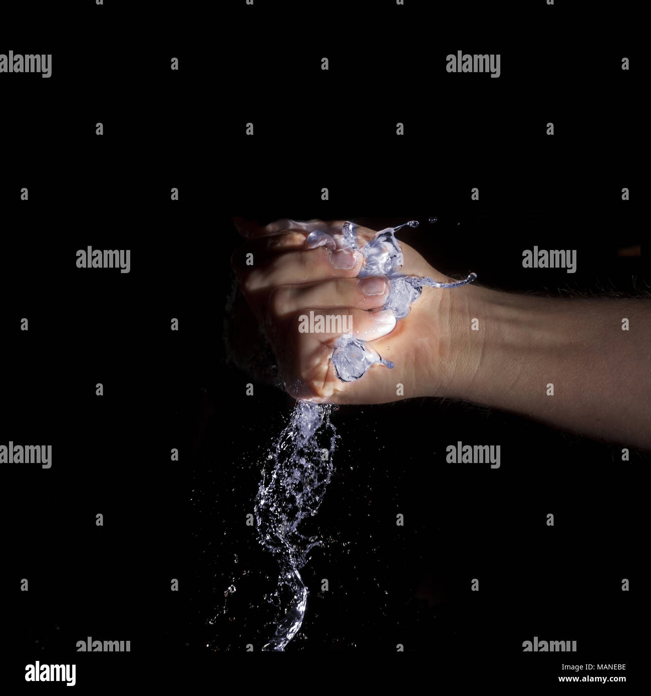 hand holding blue glowing water on black background Stock Photo - Alamy