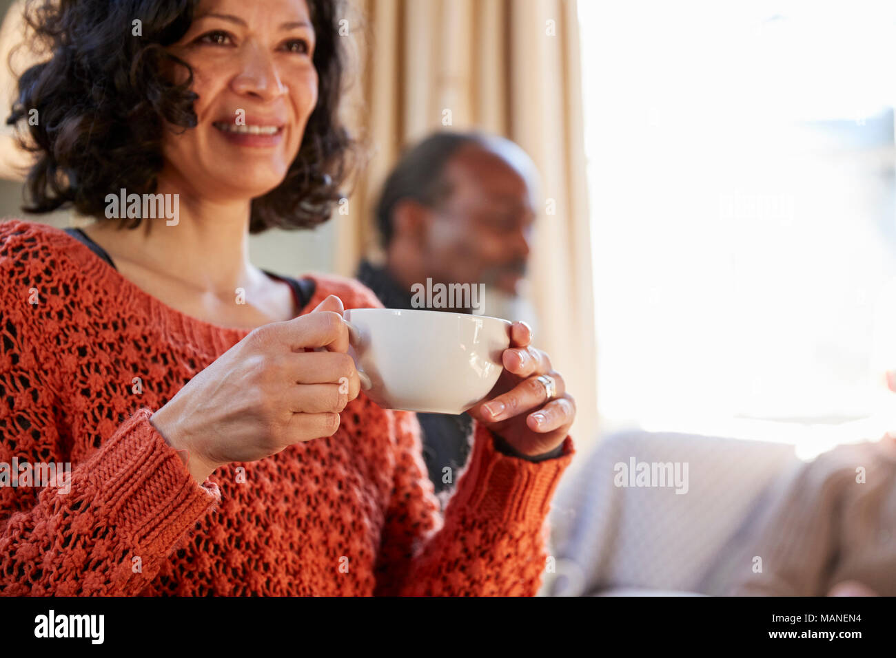 Middle Aged Woman Meeting Friends Around Table In Coffee Shop Stock ...