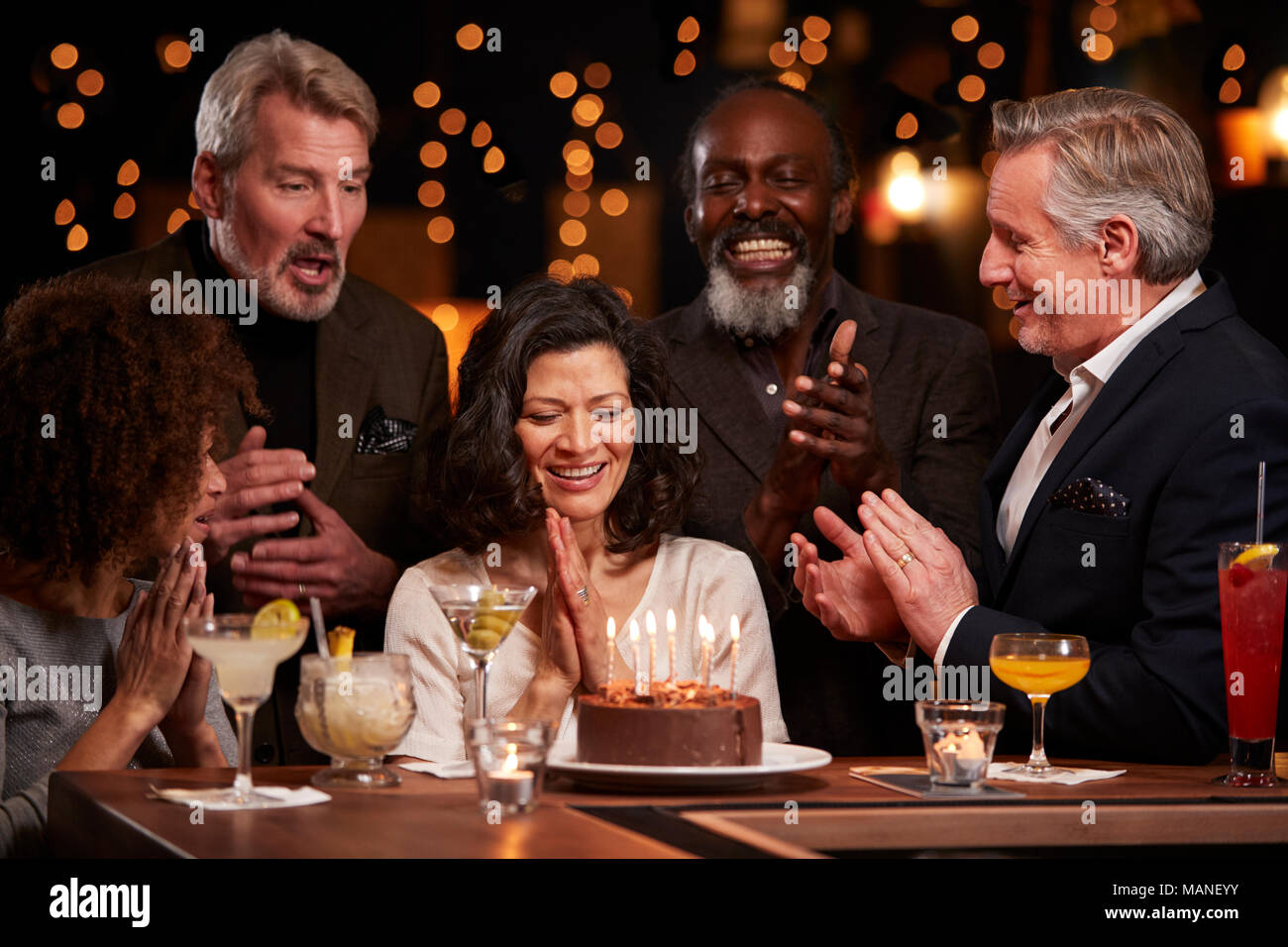 Group Of Middle Aged Friends Celebrating Birthday In Bar Stock Photo ...