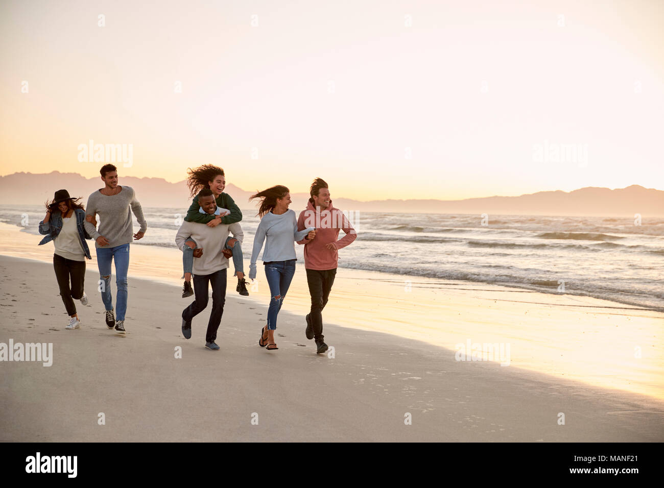Group running into sea hi-res stock photography and images - Alamy