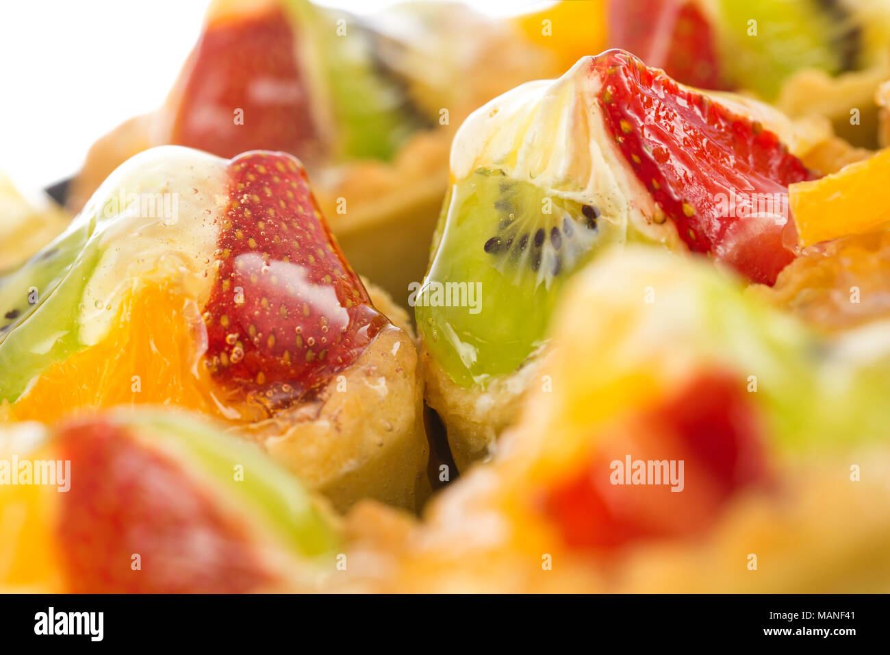 Group of fruit tartlets on white background. Shallow dof Stock Photo ...