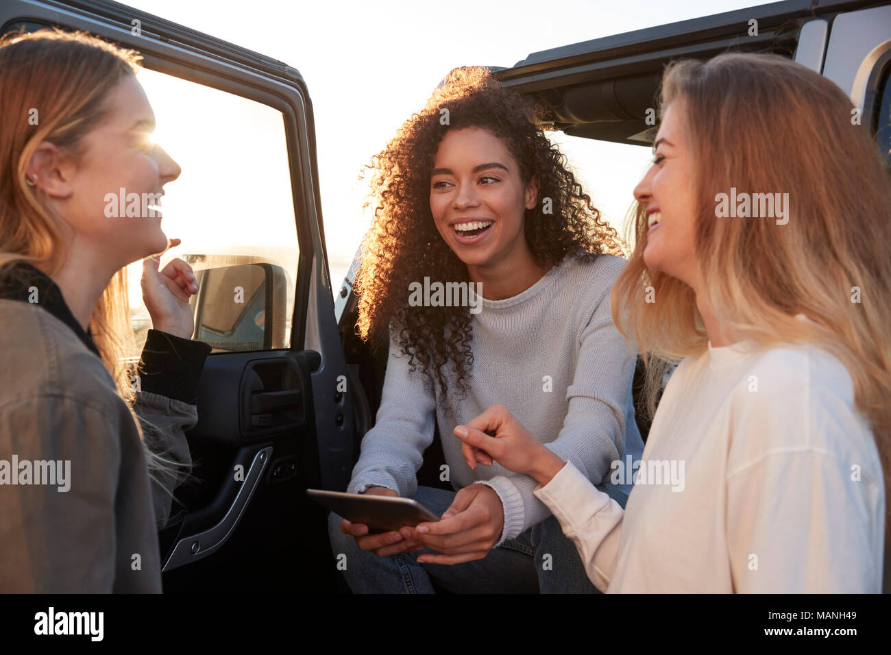 Female friends planning road trip route with tablet computer Stock ...