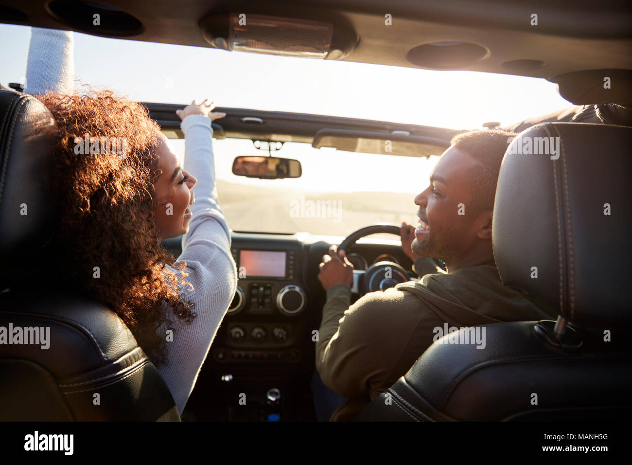 Couple drive looking at each other, rear passenger POV Stock Photo - Alamy