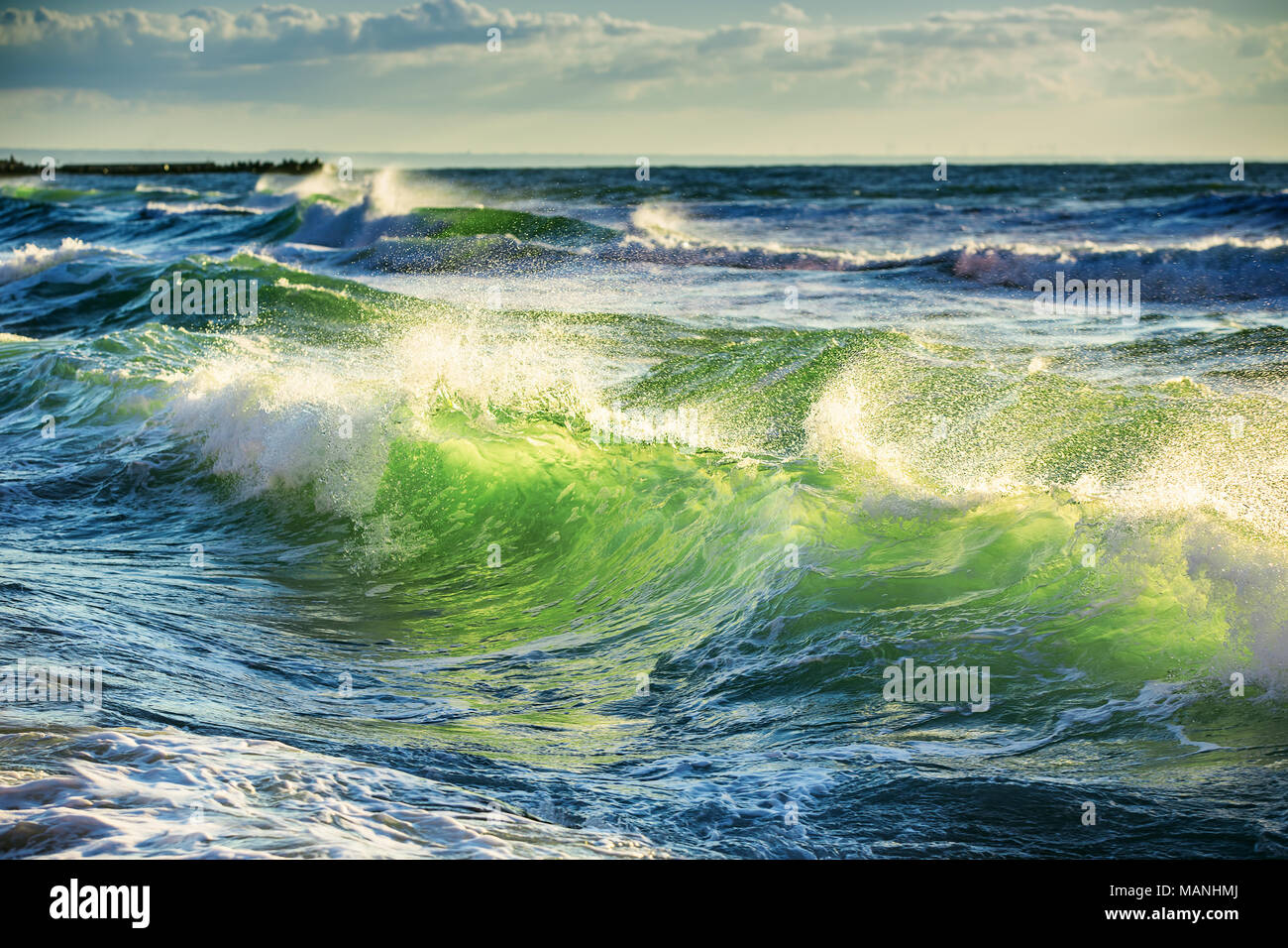 Beautiful green sunrise wave Stock Photo - Alamy