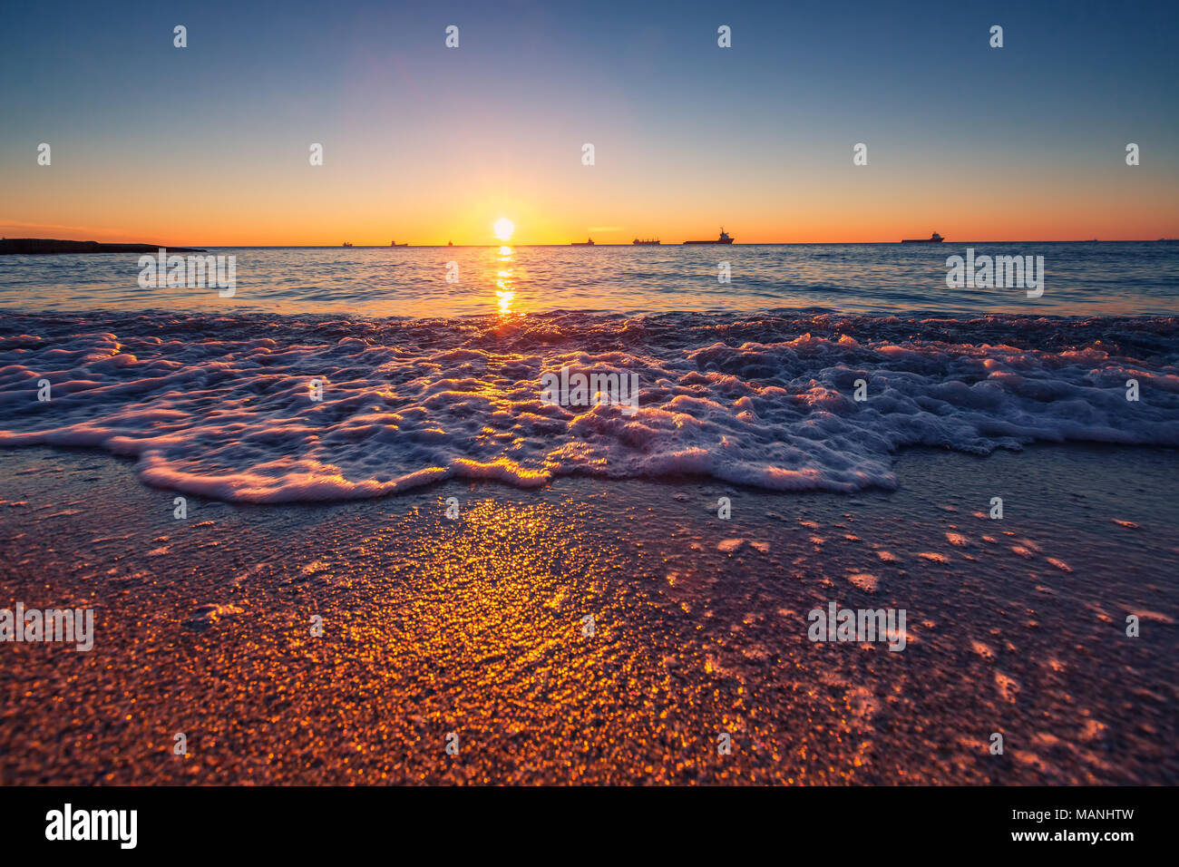 Sunrise sea sun sky boats water clouds hi-res stock photography and ...