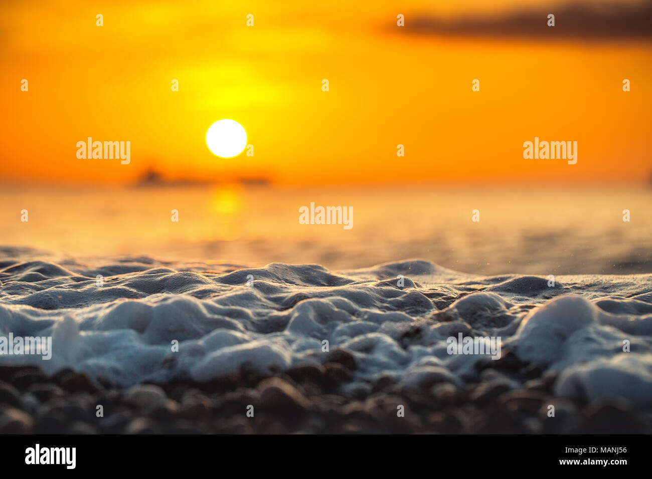 Sunrise light shining on ocean wave Stock Photo - Alamy