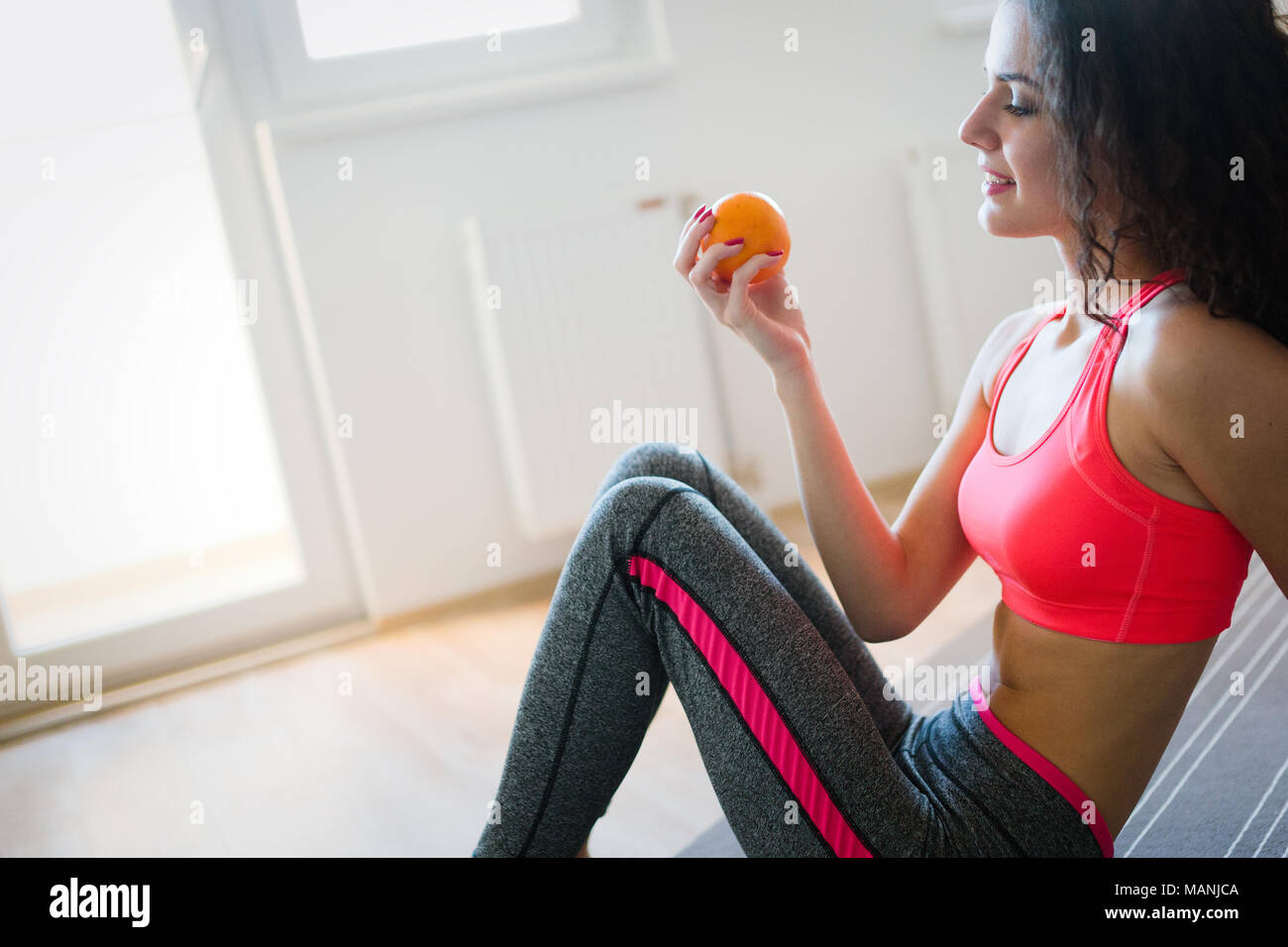 Fitness woman eating healthy food after workout Stock Photo - Alamy