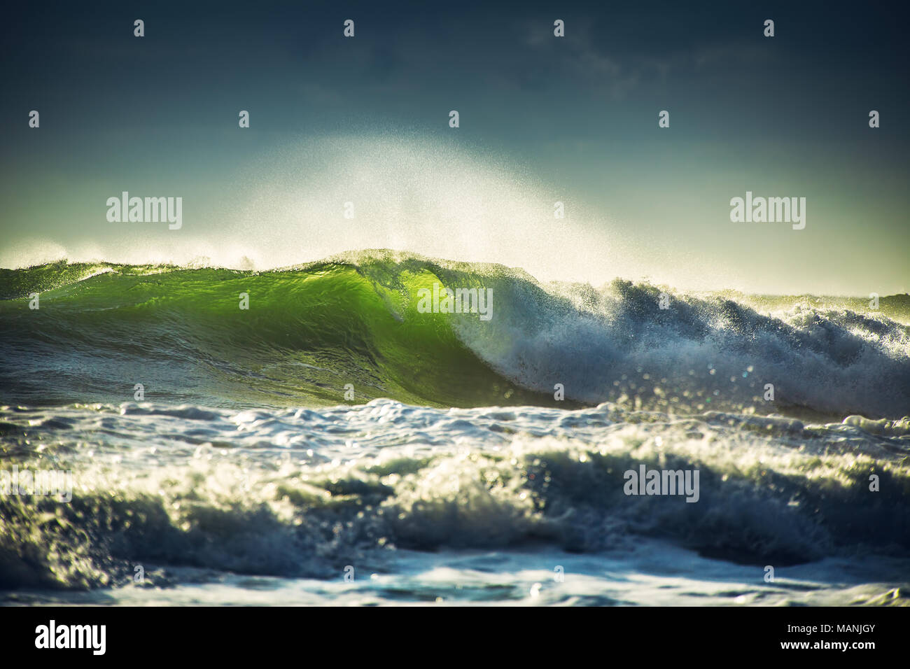 Beautiful green sunrise wave Stock Photo - Alamy