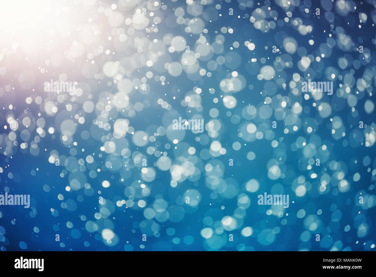 Snow bokeh texture on blue background Stock Photo - Alamy