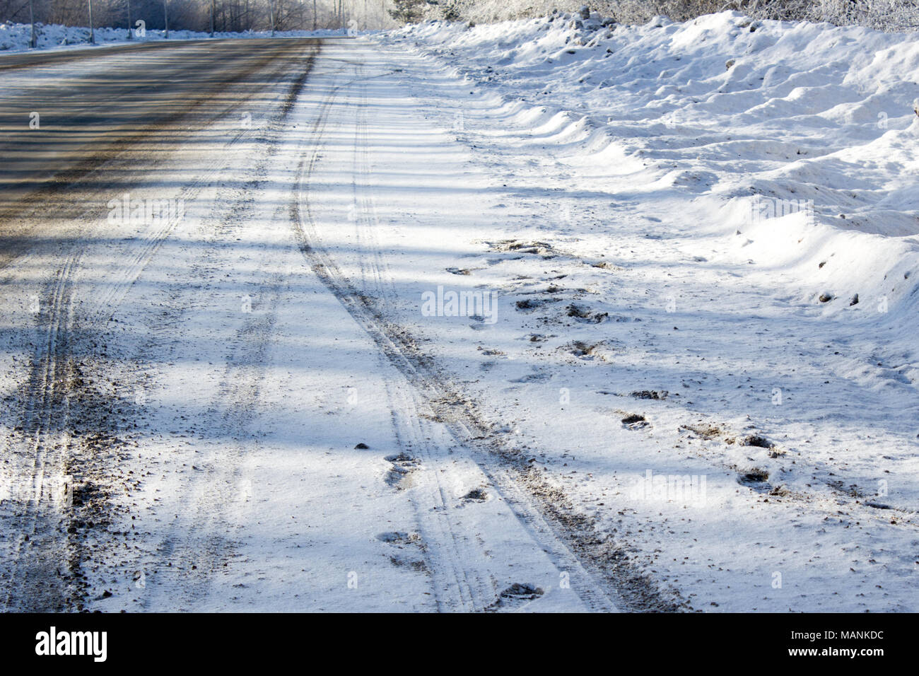Winter road with tire tracks in the snow Stock Photo - Alamy