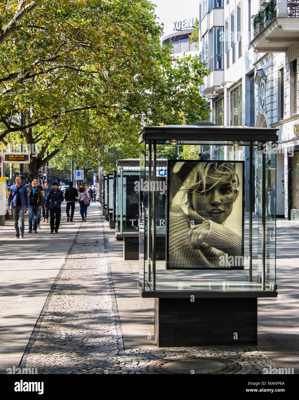 Berlin, Charlottenburg. People walking past Store display cases that ...