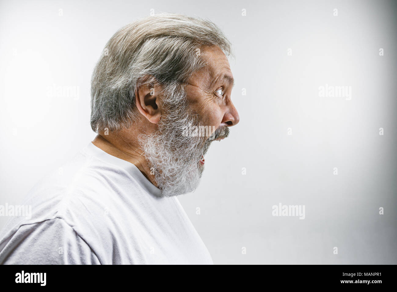 The senior emotional angry man screaming on white studio background ...