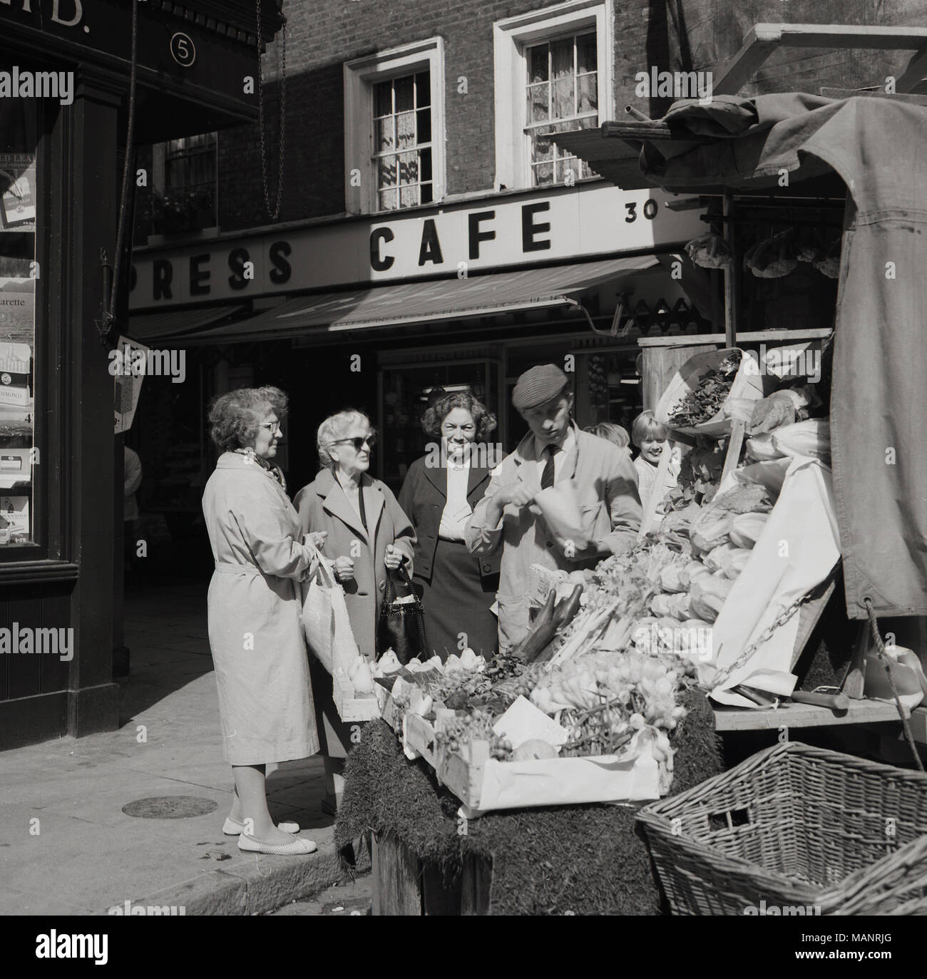 1950s, historical, London, three ladies buying fruit from a small ...