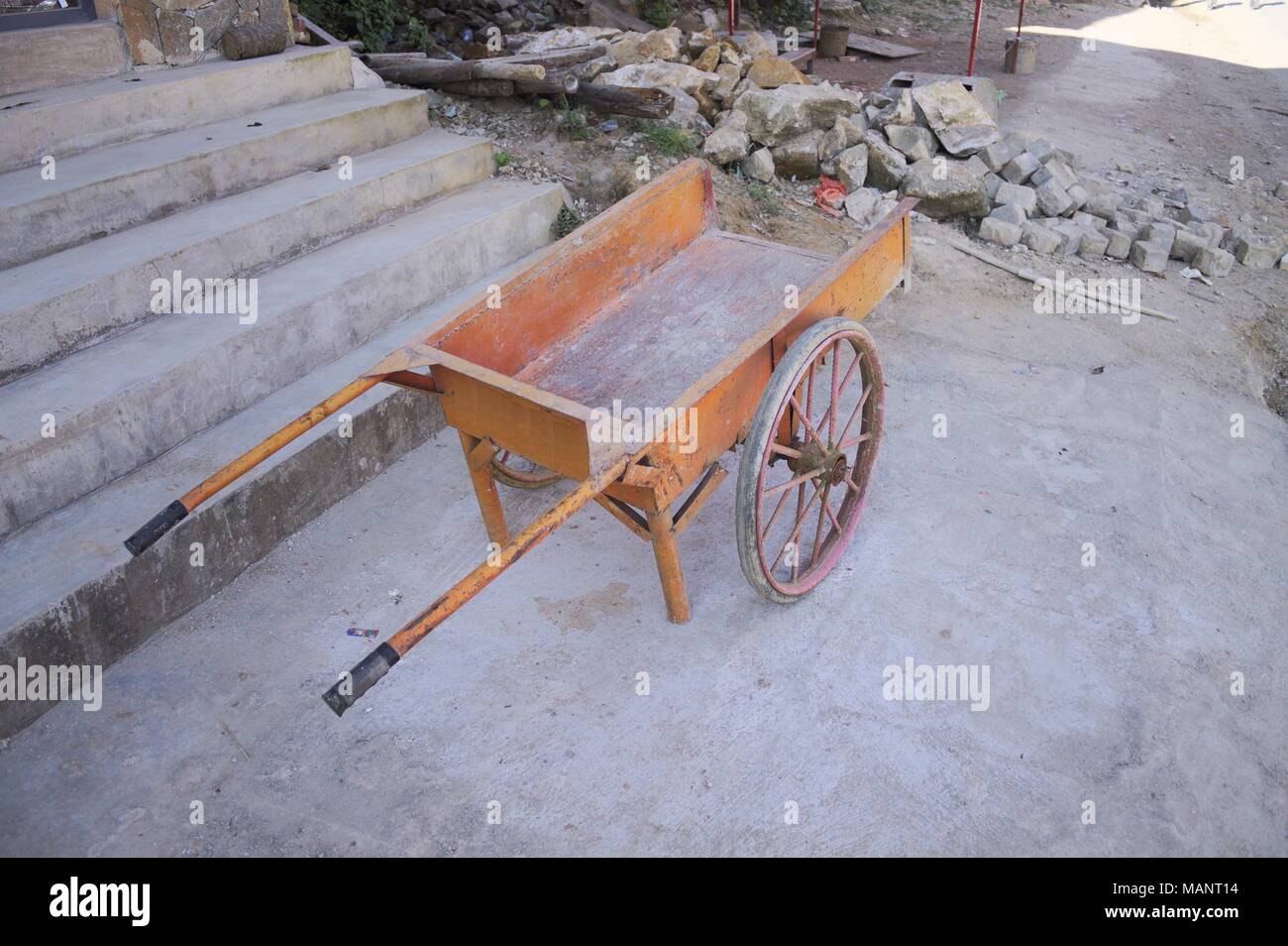 Orange wheelbarrow on the street (Yuanyang, Yunnan, China Stock Photo ...