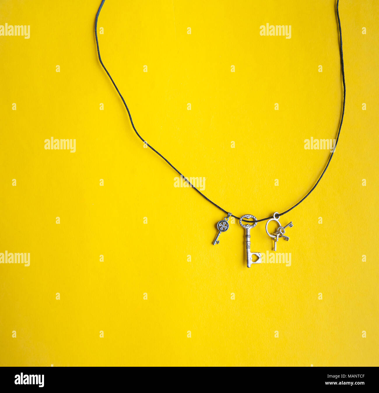 decorations of keys on a cord on a yellow background Stock Photo - Alamy