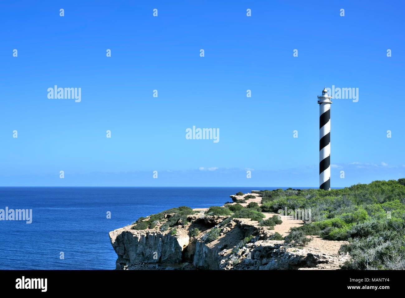 Beacon or striped lighthouse on Ibiza Island. Black and white ...