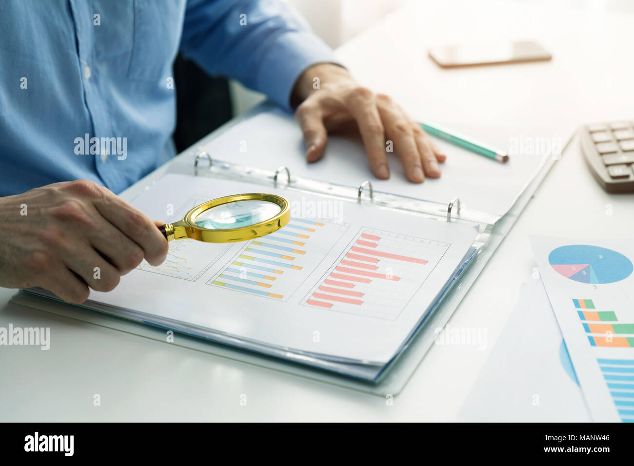 internal audit concept - man with magnifying glass inspecting business ...