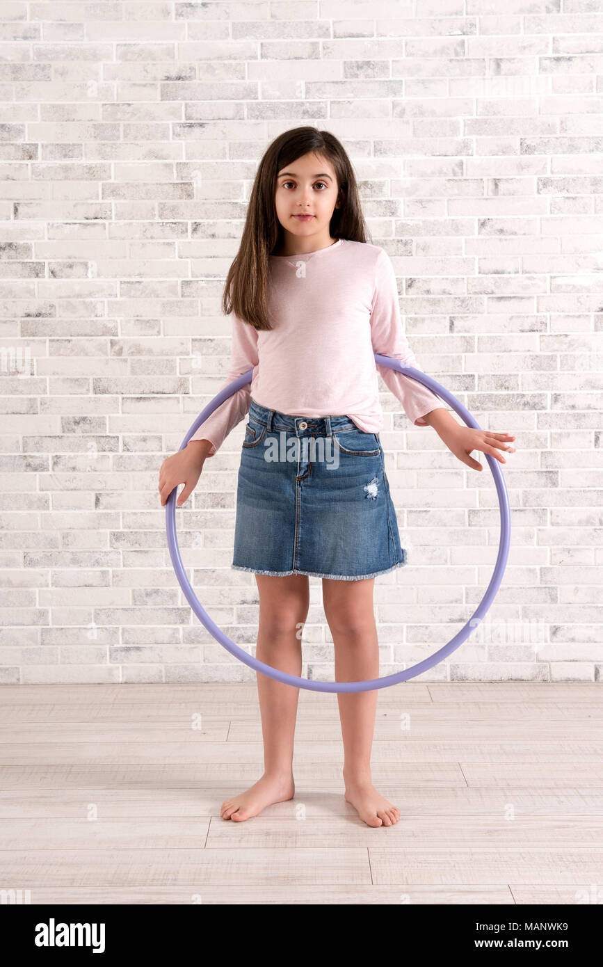 Young pretty barefoot girl in casual clothes posing barefoot while ...