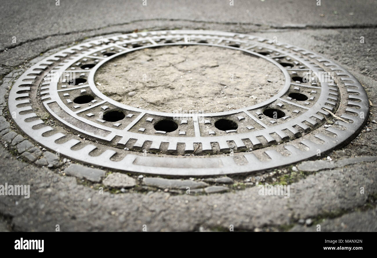 Gully or manhole on an old street. Detail shot Stock Photo - Alamy