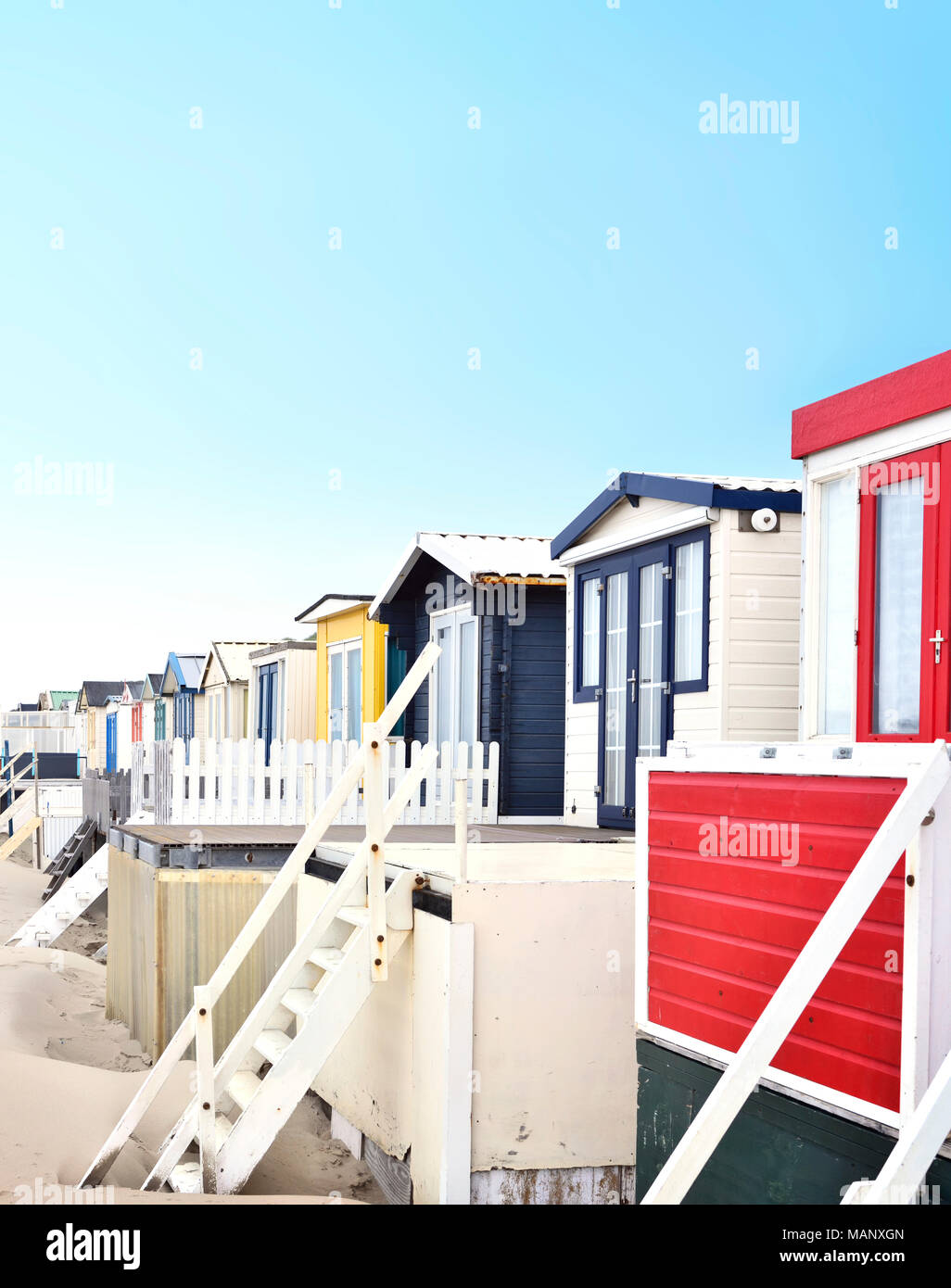 Beautiful painted beach huts or small houses onto a beach. Beach dunes ...