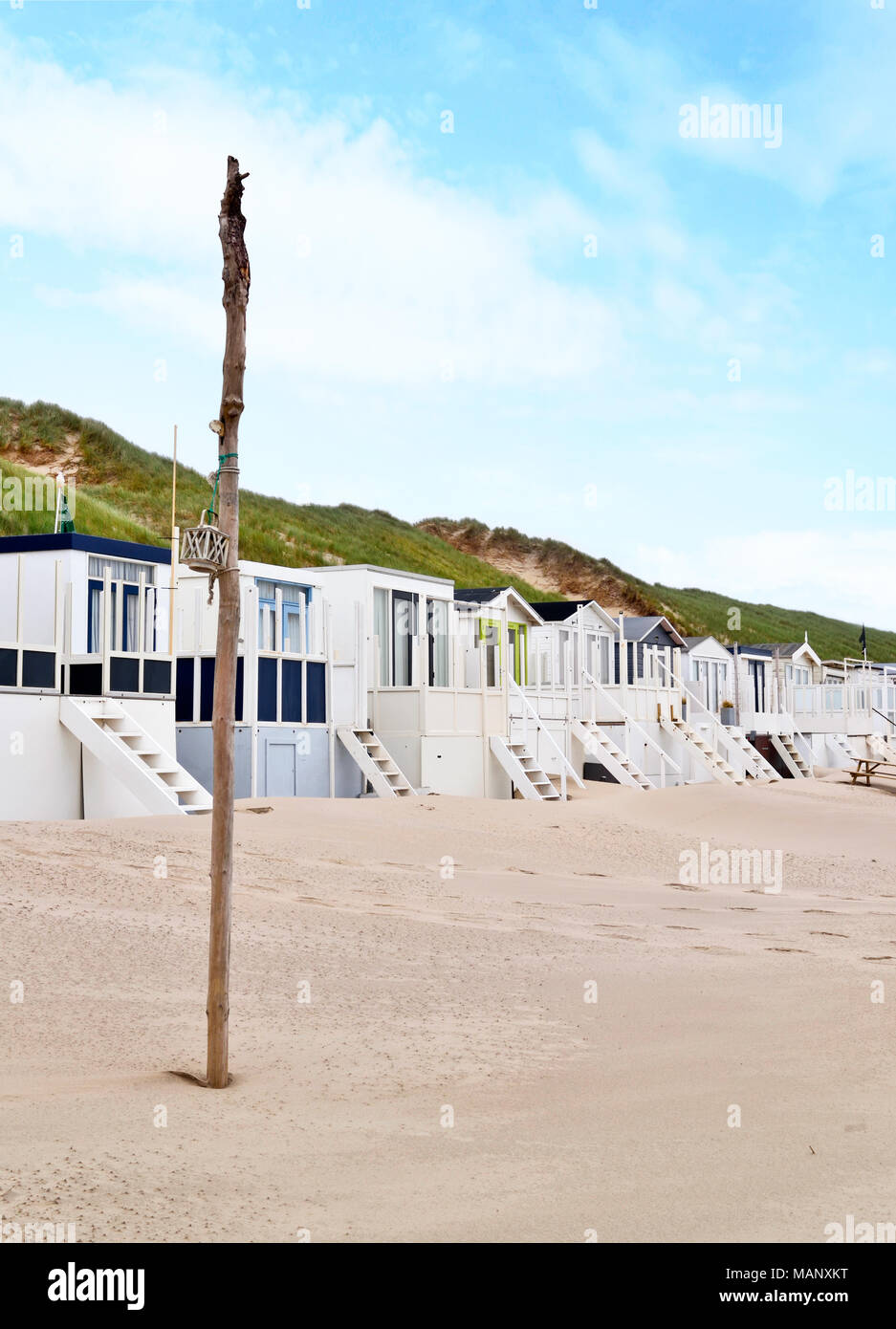Beautiful painted beach huts or small houses onto a beach. Beach dunes ...