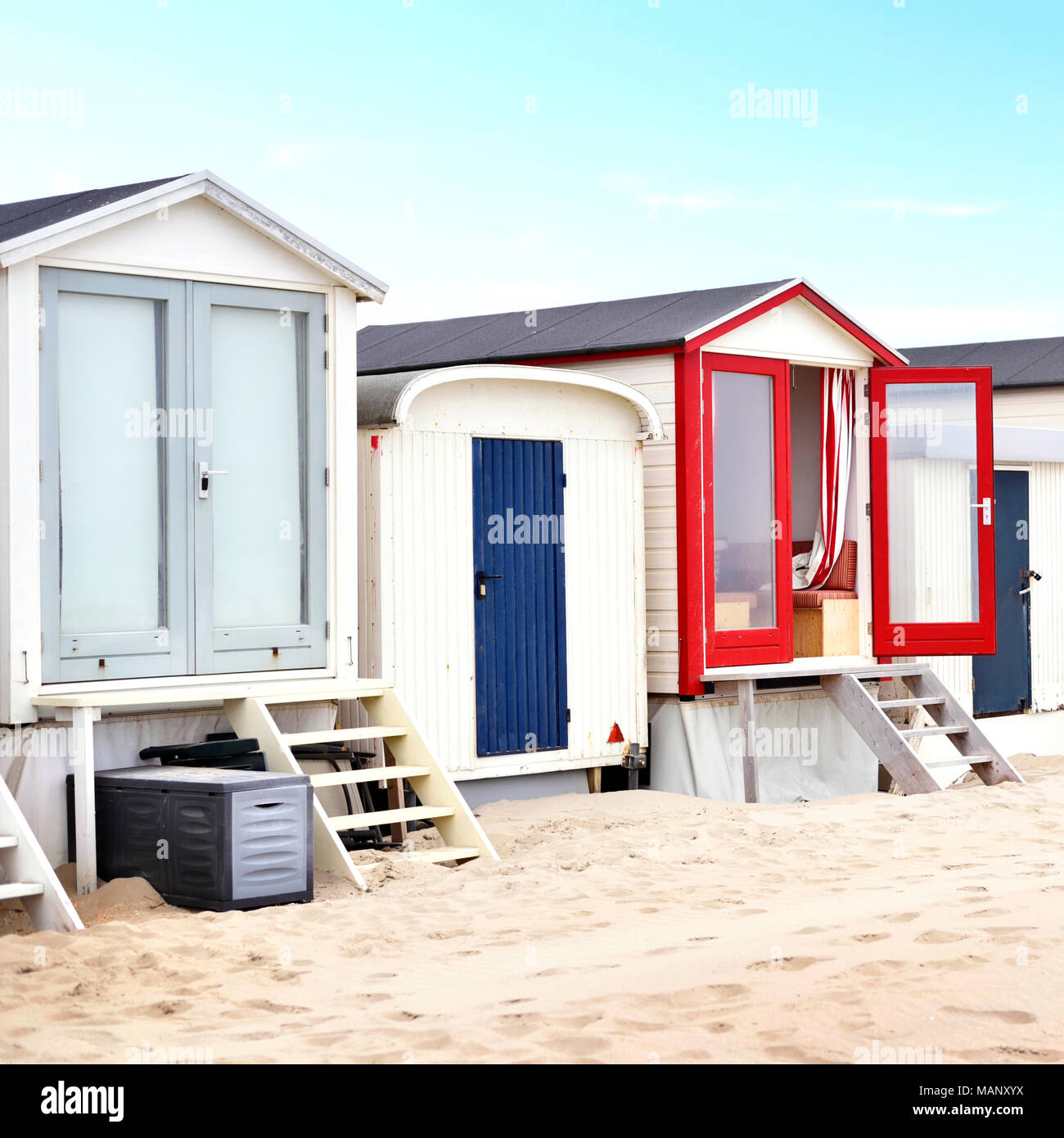 Beautiful painted beach huts or small houses onto a beach. Beach dunes ...