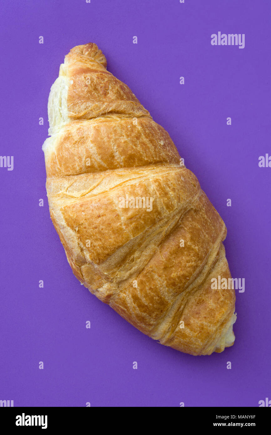 Croissant on violet background Stock Photo - Alamy